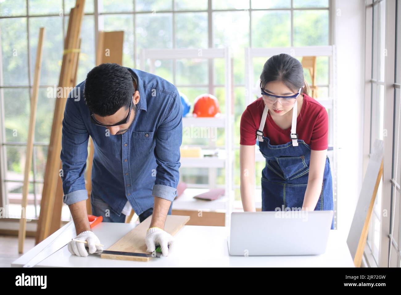 Carpenter grinding joinery product with carvings, finishing woodwork at ...