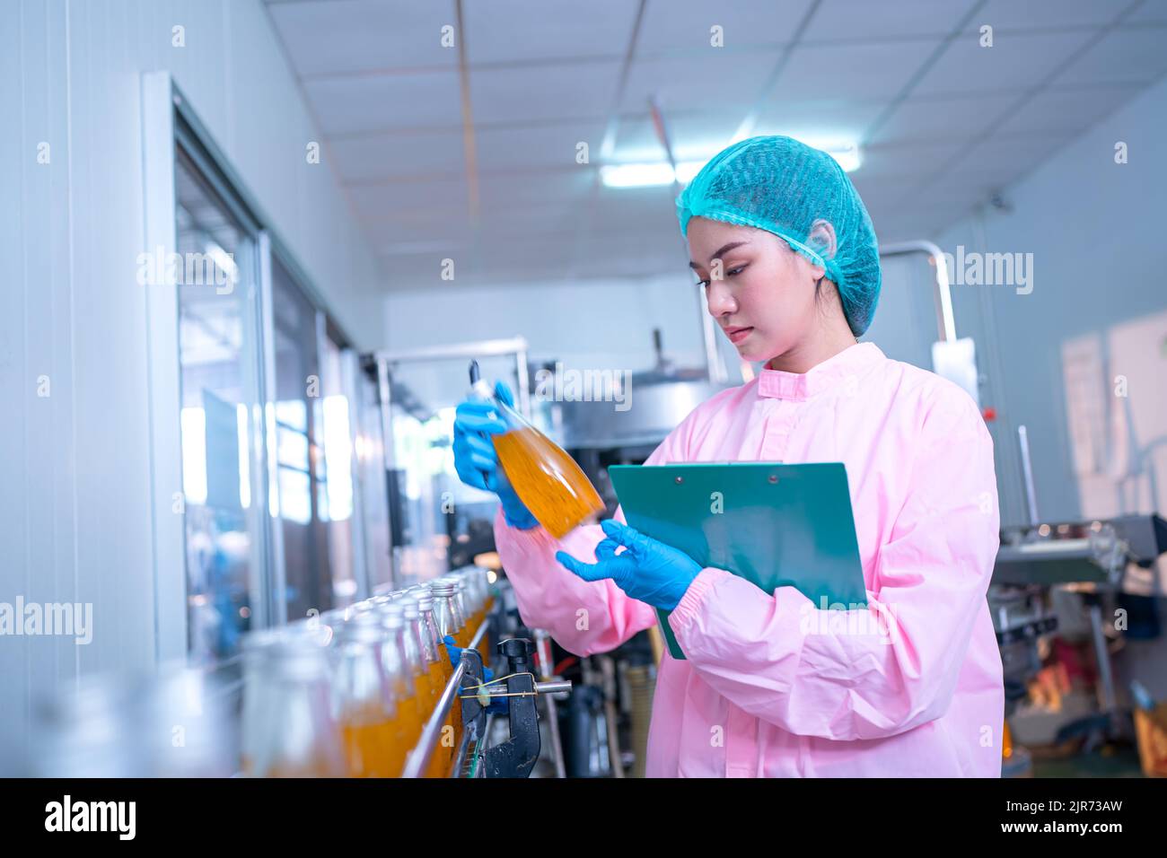 Engineer working at Fruit juice Bottle Automated conveyor belt ...