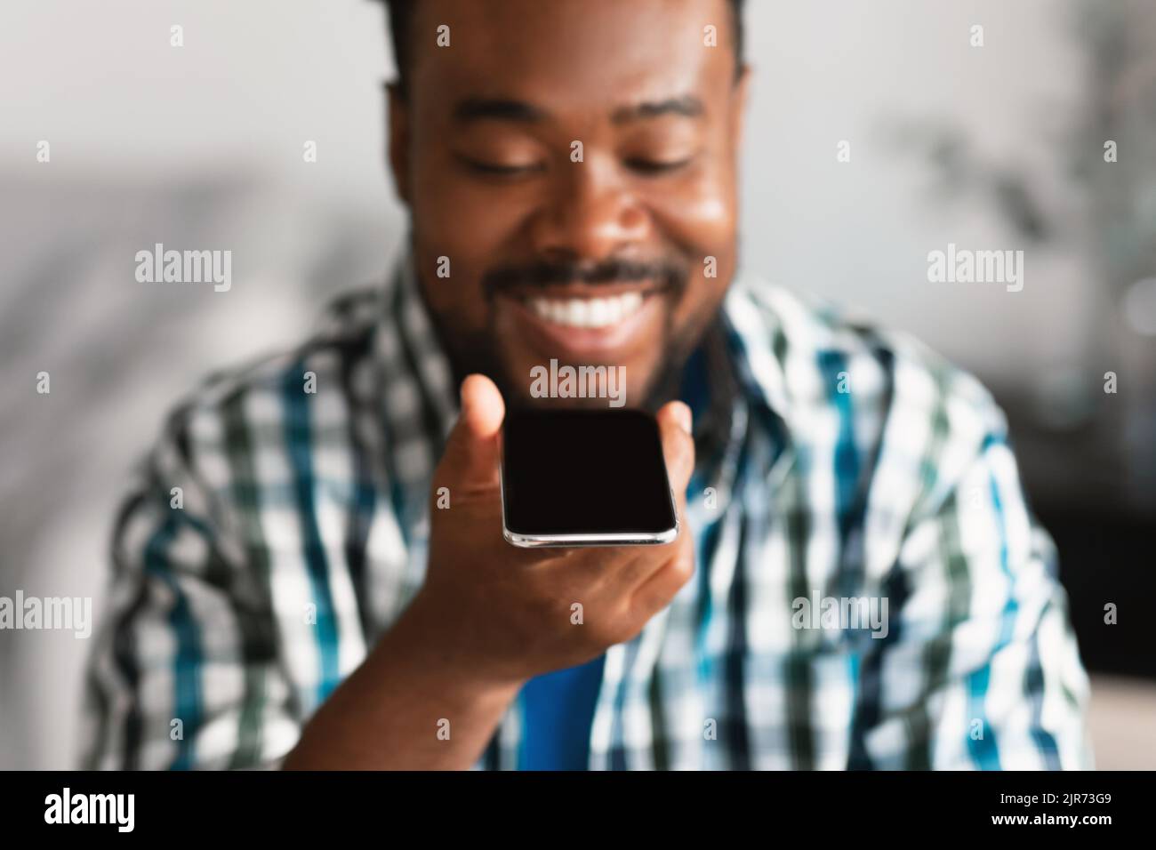 Happy Black Man Using Voice Assistant Application On Phone Indoors ...