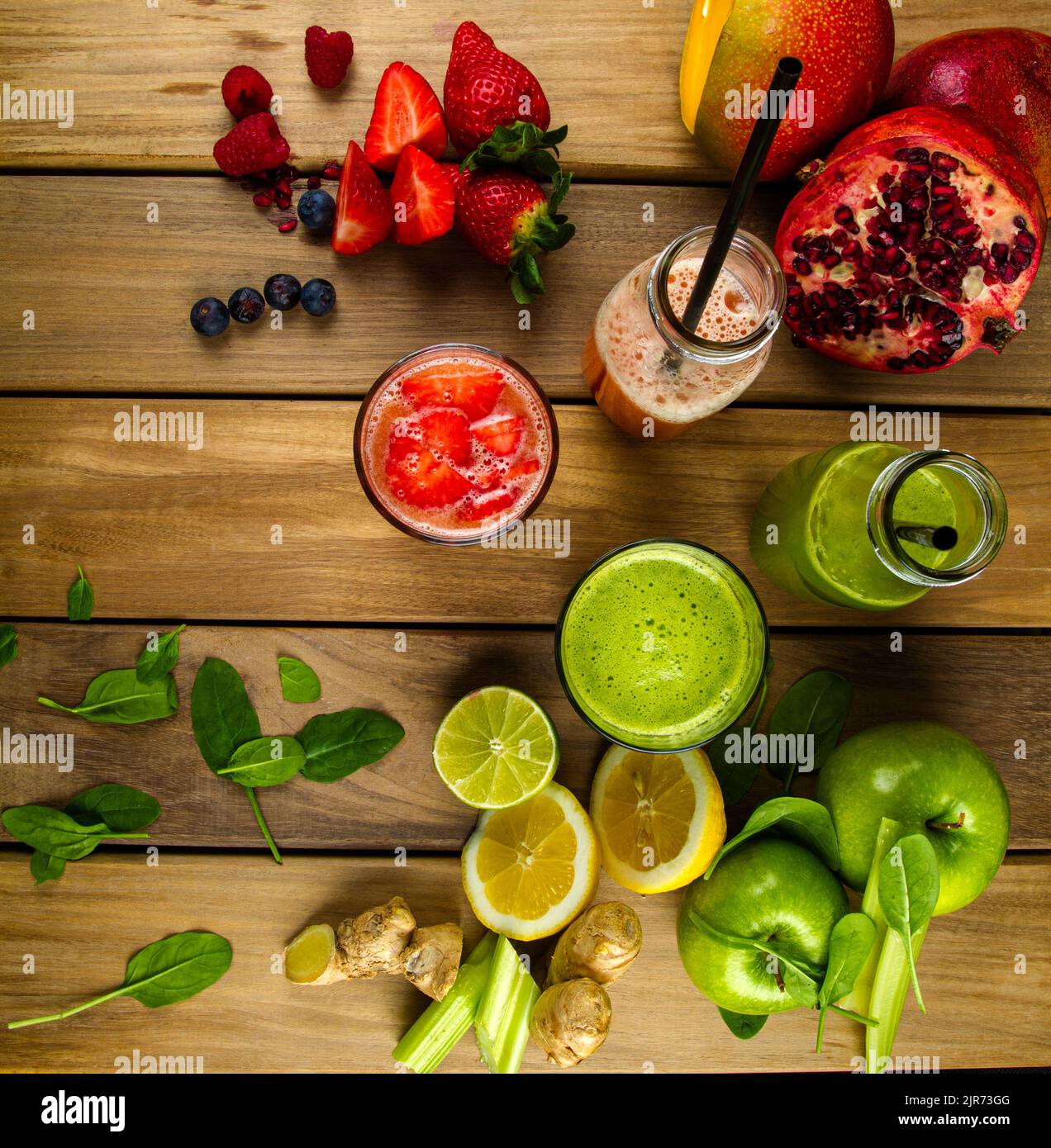 Fresh prepared fruit juices photographed from above on wood background ...