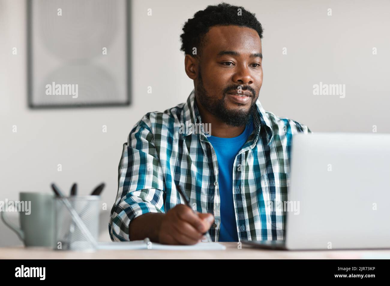 Young black man taking notes hi-res stock photography and images - Alamy