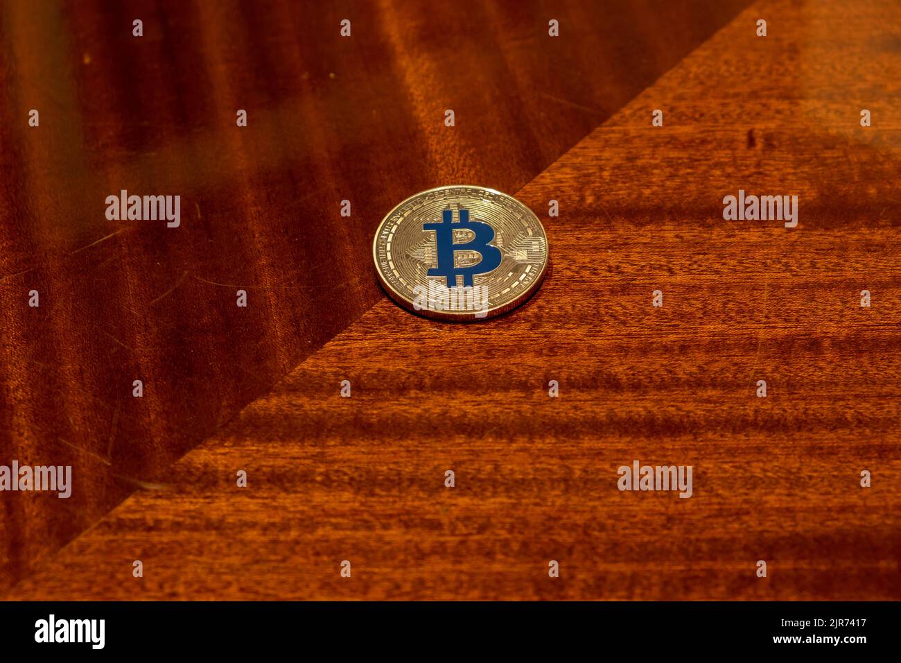 Bitcoin gold coin put on a brown wooden table background. Trading and ...