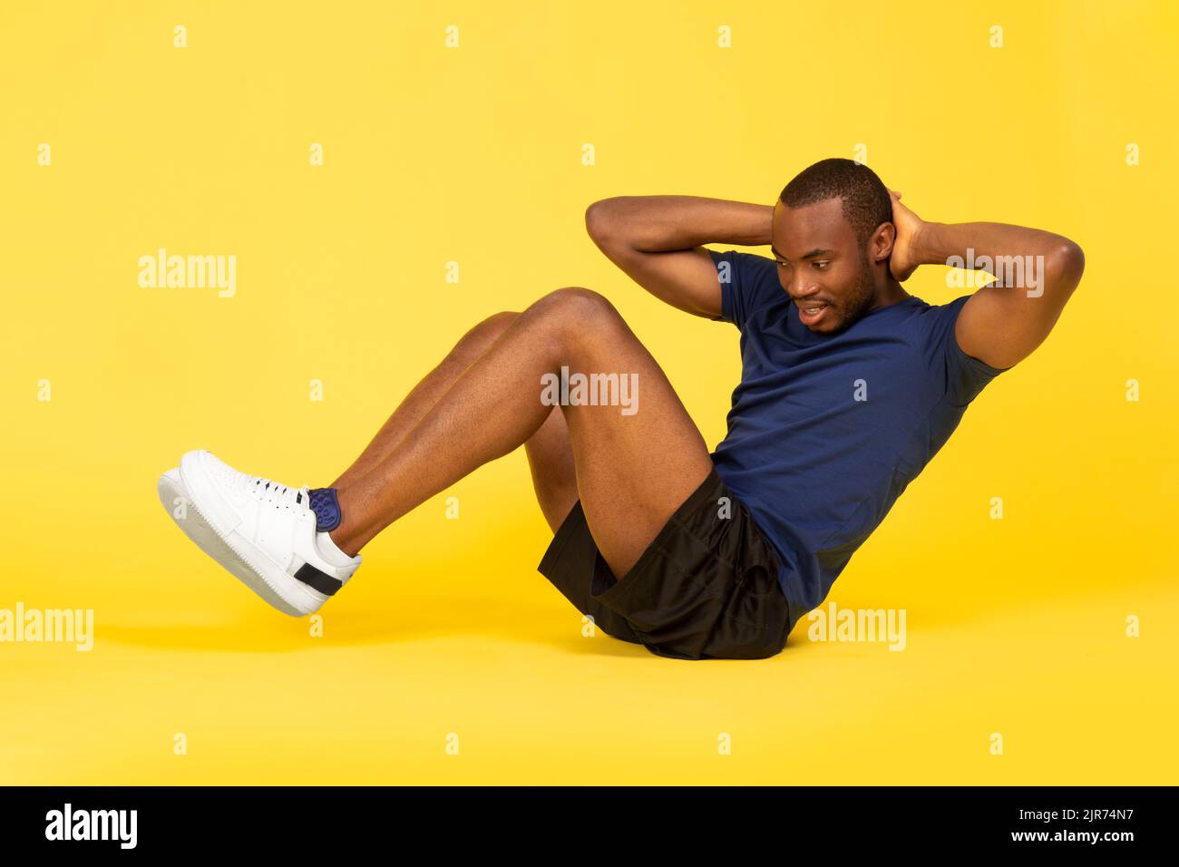 Black Fitness Guy Doing Sit Ups Exercise On Yellow Background Stock ...
