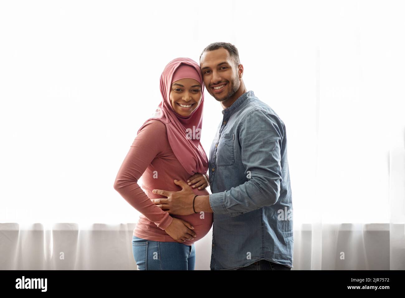 We'll Be Parents. Happy Pregnant Islamic Spouses Posing Near Window At ...