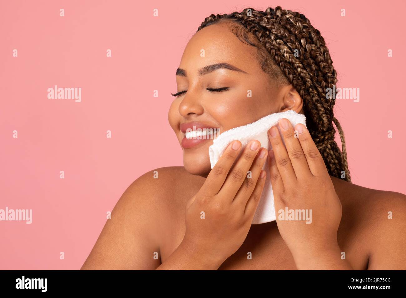 African American Lady Drying Face With Towel Over Pink Background Stock ...