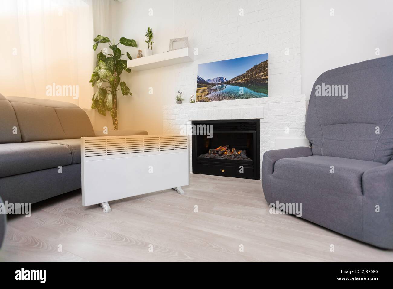 Modern electric heater in stylish room interior Stock Photo - Alamy