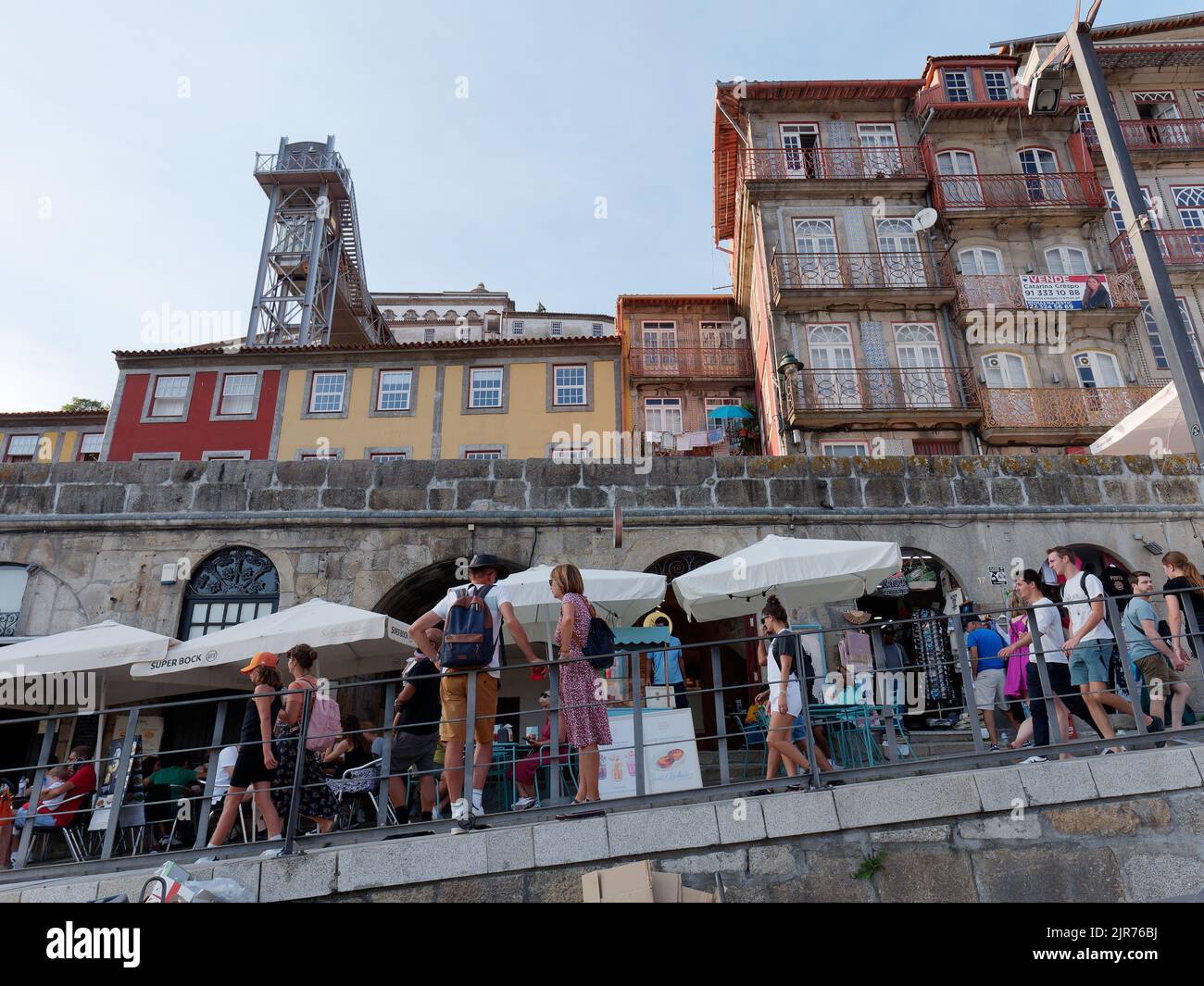 People walking along the riverside promenade in the Ribeira district of ...