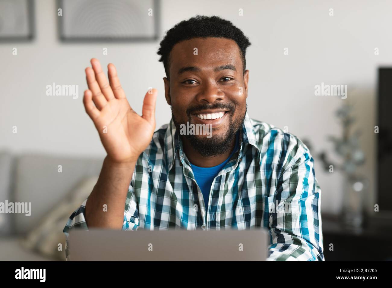 Black Freelancer Guy Waving Hand To Laptop Video Calling Indoor Stock ...