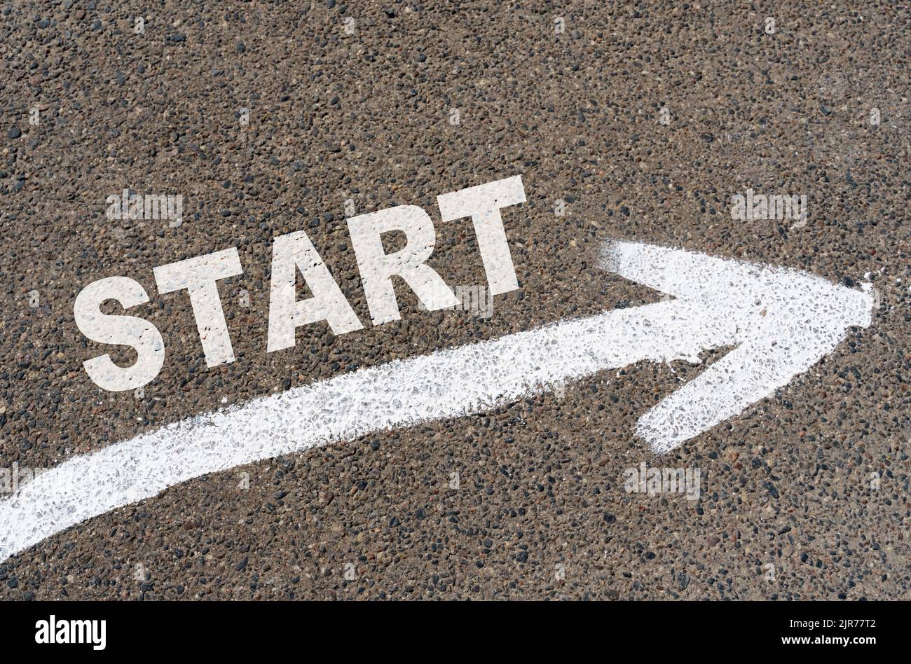 Business concept. On the asphalt road markings an arrow with the ...