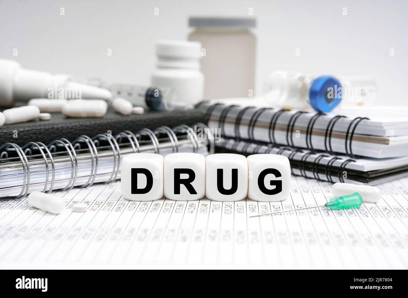 Medicine concept. On the table are diaries, medicines and cubes with ...