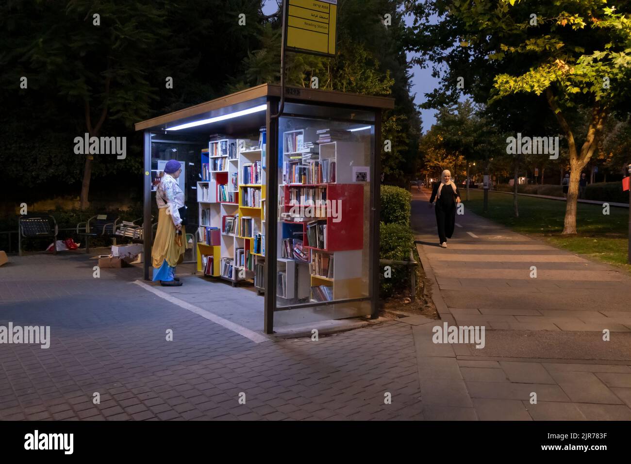 A woman looks at books inside a bus station which was transformed into ...