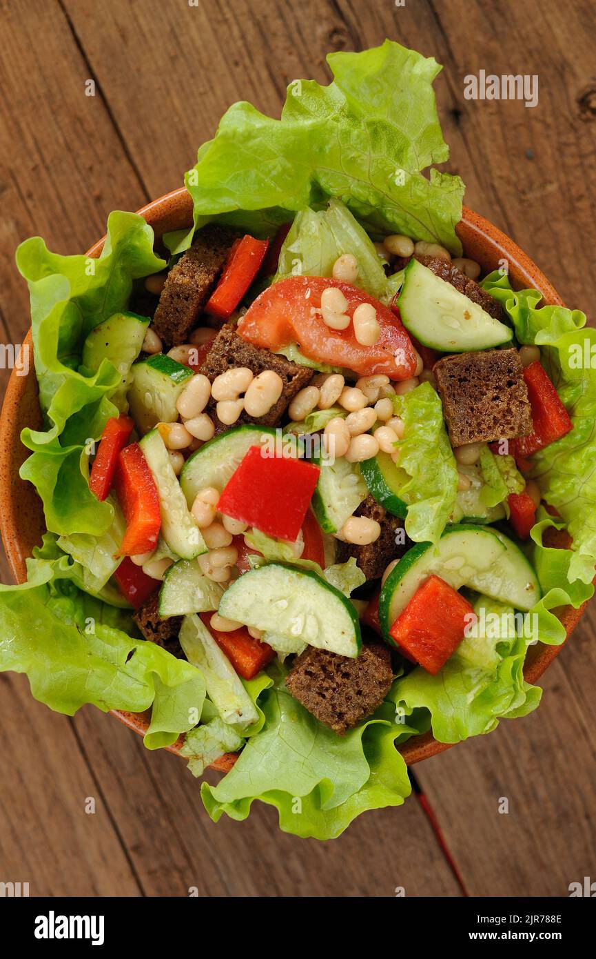Vegetable salad with white beans, rye toasts, tomatoes, cucumber and ...