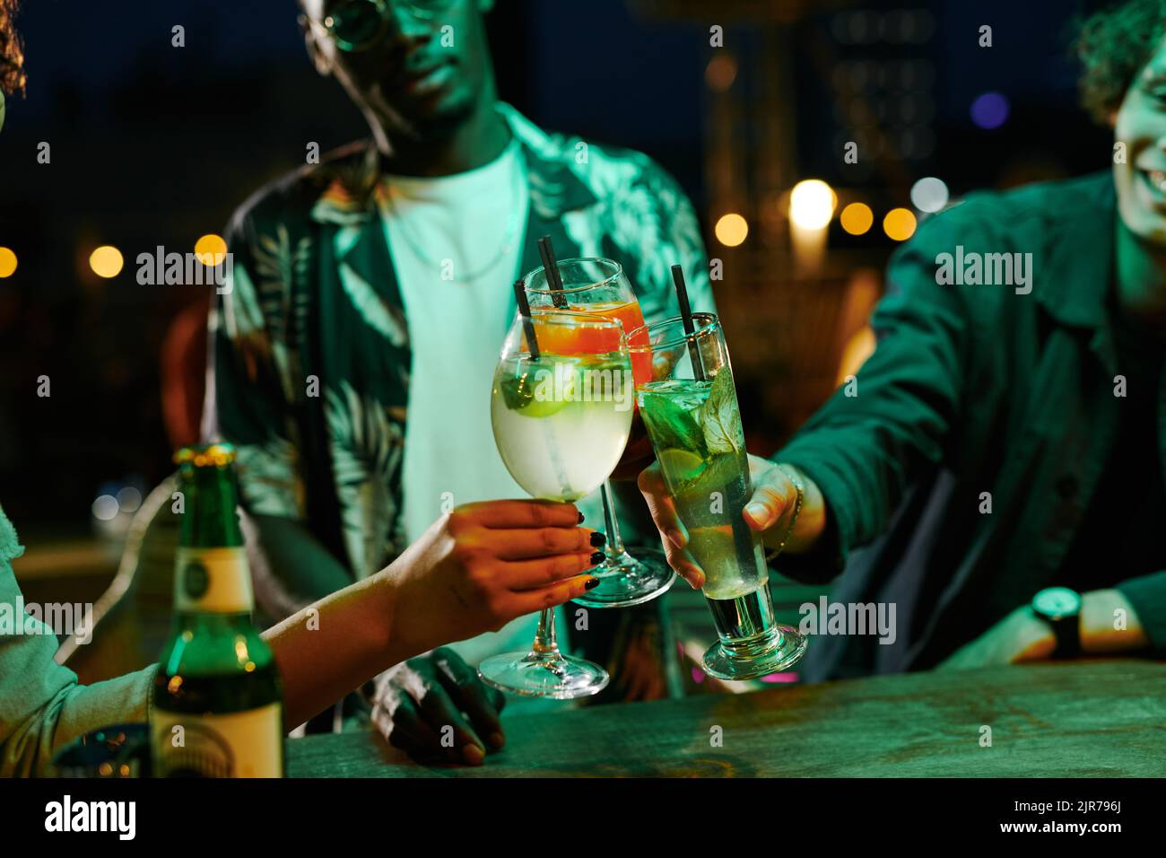 Group of youthful intercultural people in casualwear toasting with ...