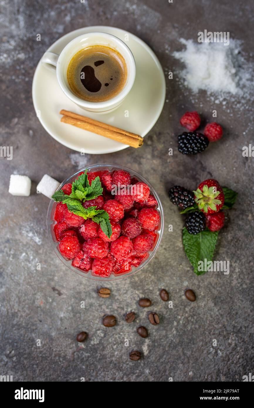 top view dessert with fresh raspberries and a cup of coffee on a ...