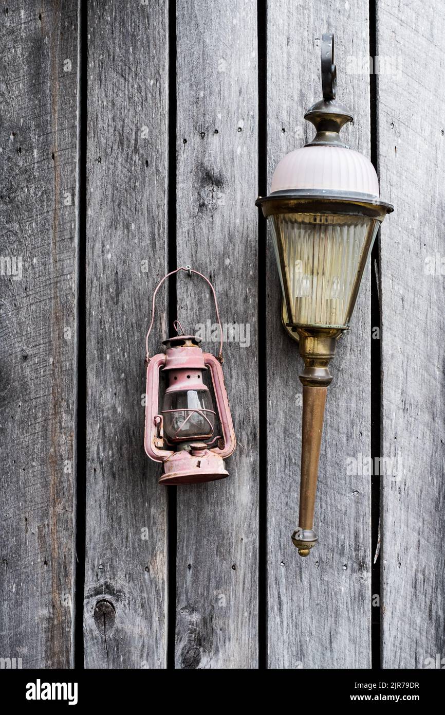 A vertical shot of vintage lanterns hung up on a barn door in Amish ...