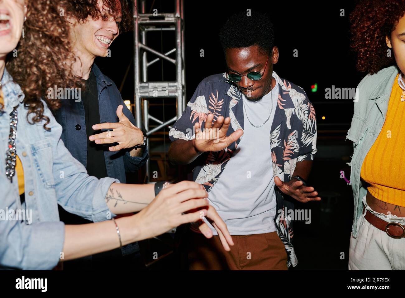 Young cheerful multicultural people in stylish casualwear enjoying ...