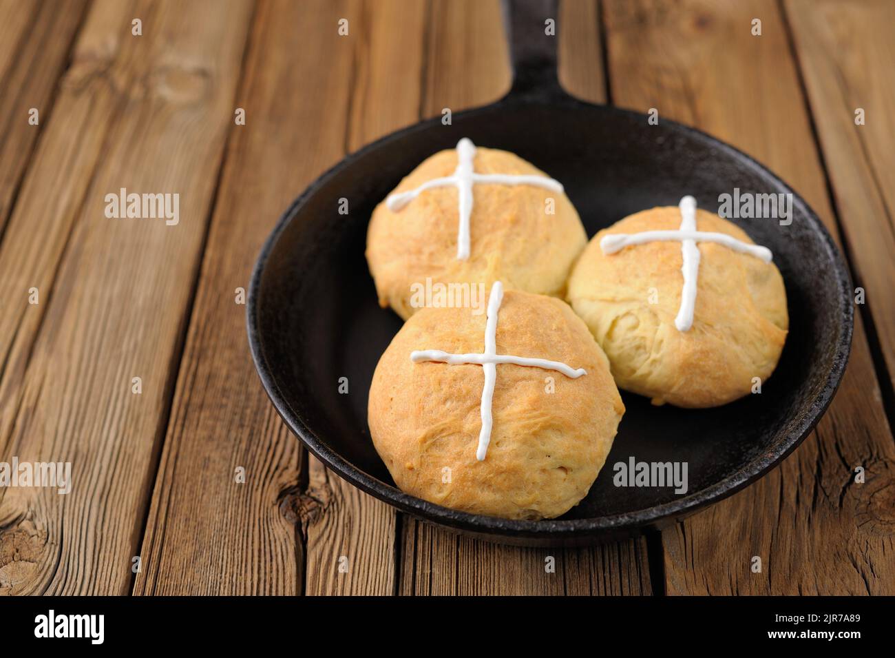 Hot cross buns in cast iron skillet on wooden background horizontal ...