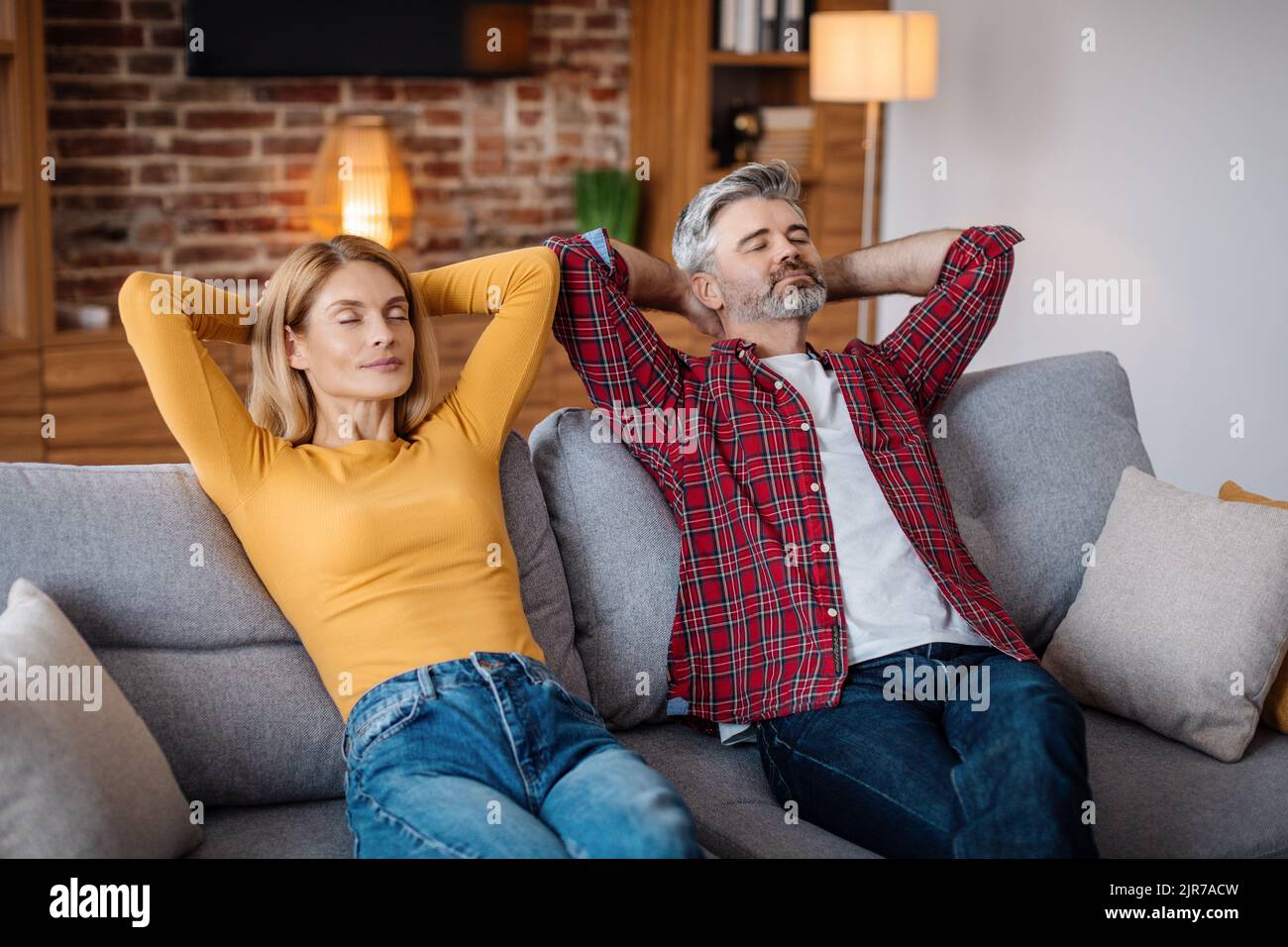 Happy calm middle aged caucasian husband and wife resting with eyes ...
