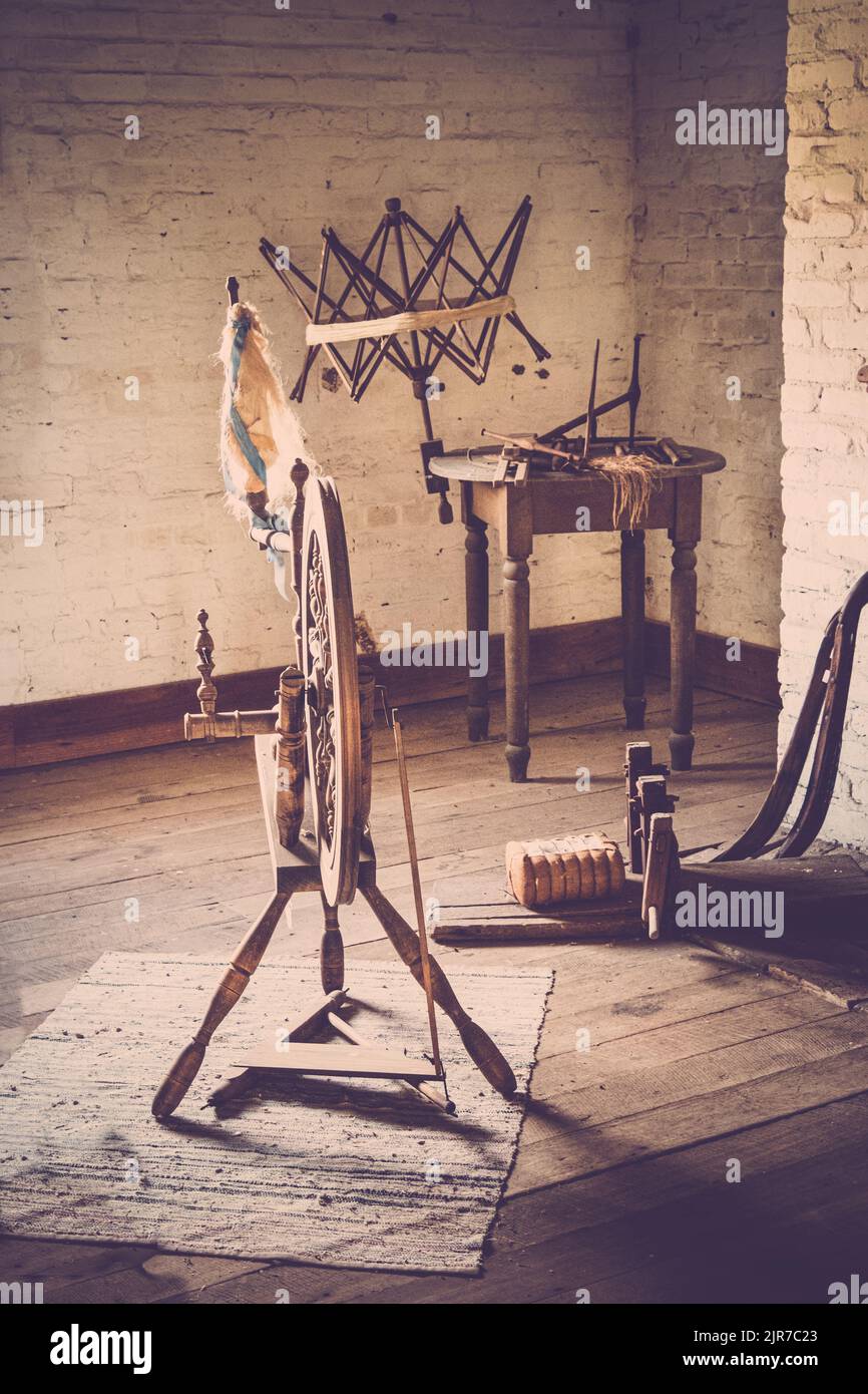 A vertical shot of a wooden spinning wheel in a museum in Tennessee ...