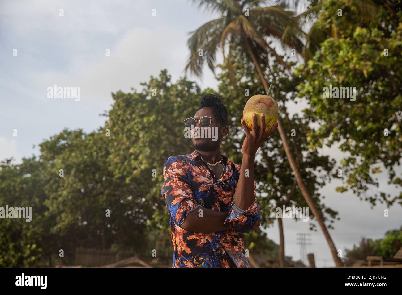 Frame of a young man looking into the distance and holding a large ...