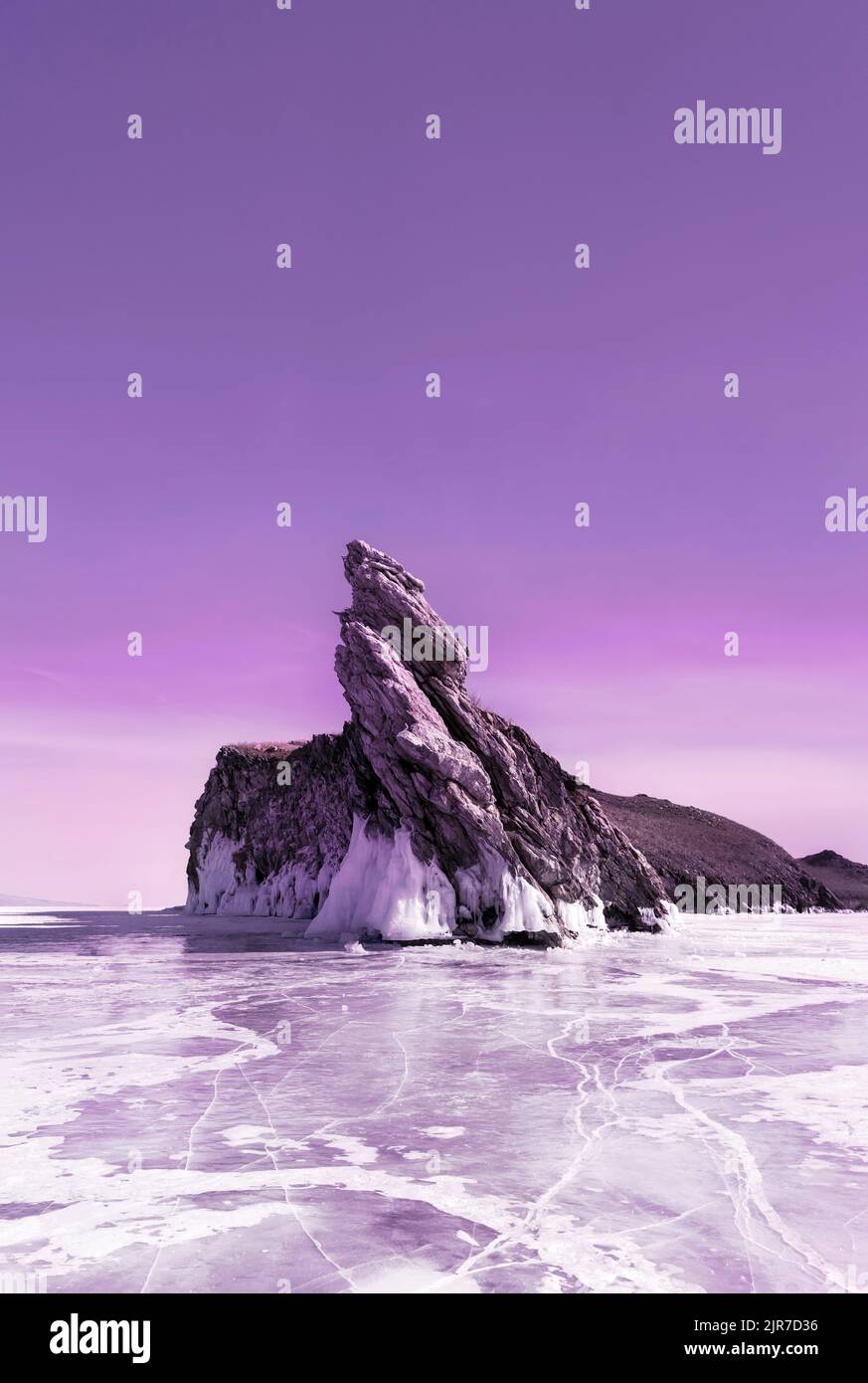 Frozen Baikal lake with transparent cracked blue ice and Ogoy island ...