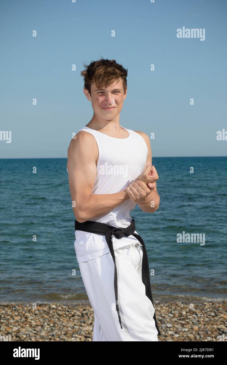 A 17 Year Old Teenage Black Belt Flexing His Muscles on A Beach Stock ...