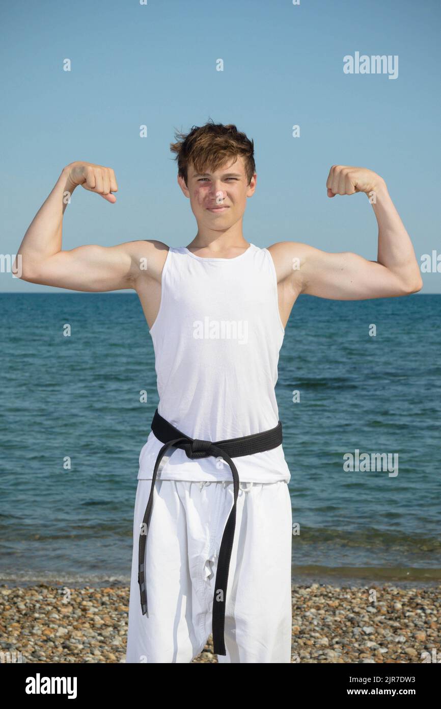 A 17 Year Old Teenage Black Belt Flexing His Muscles on A Beach Stock ...