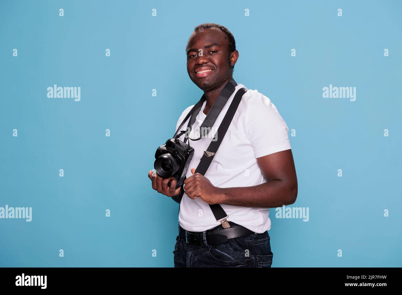 Confident professional photographer having modern camera while smiling ...