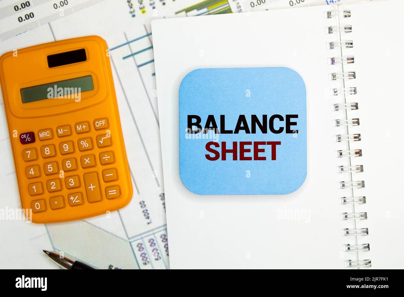 Clipboard with text BALANCE SHEET and keyboard and chart on white ...