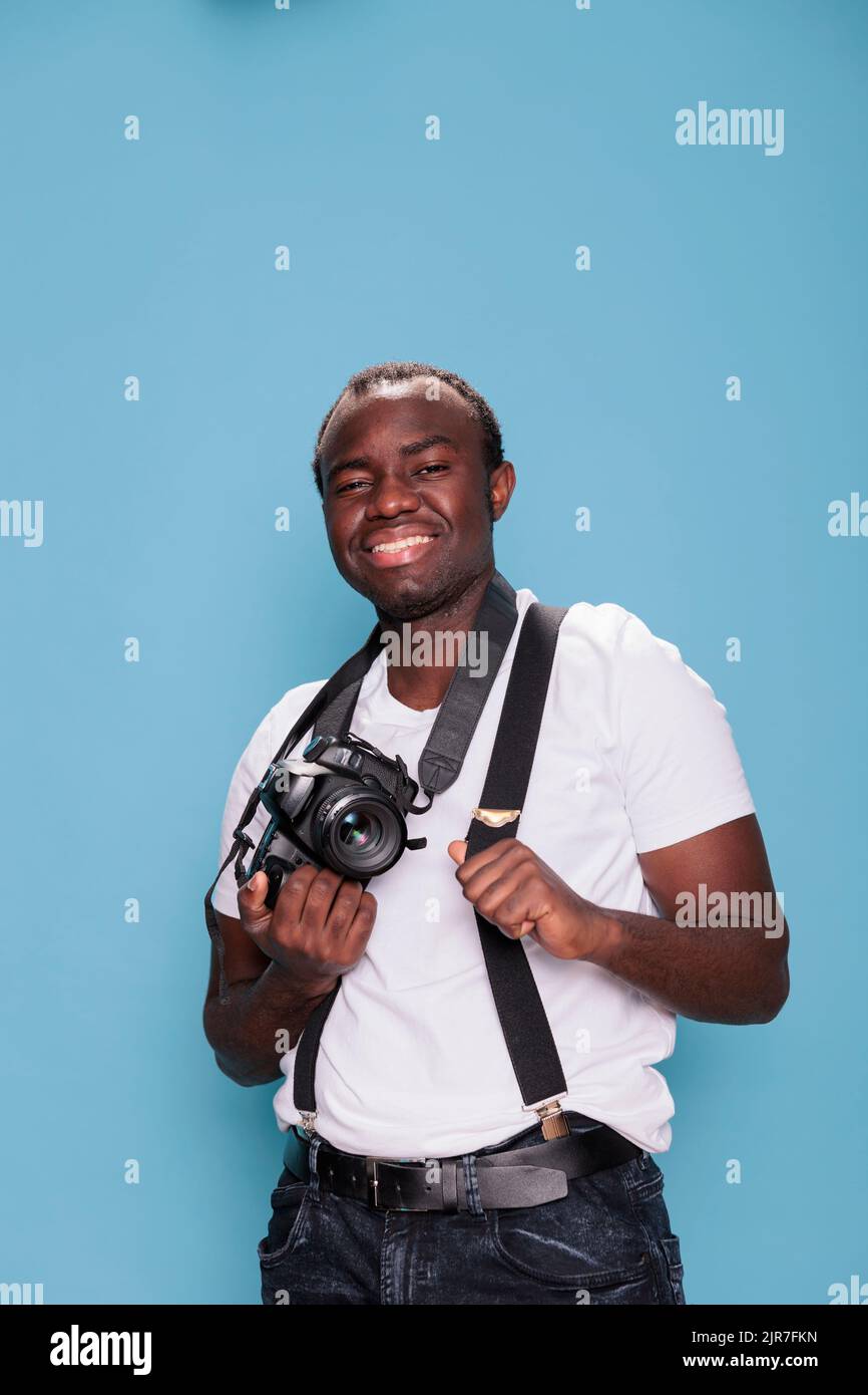 Handsome confident professional photographer posing while smiling ...