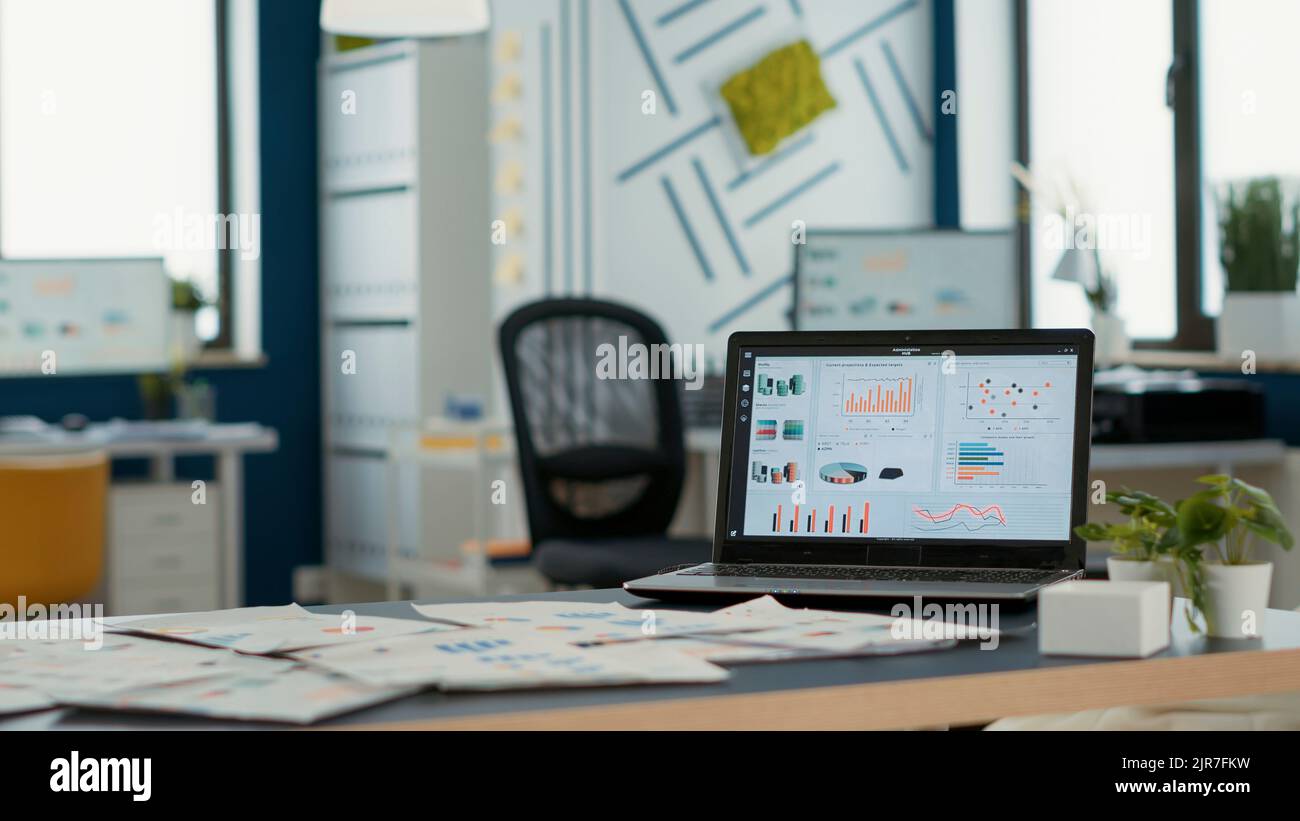 Empty startup office with laptop showing business mangement software on ...