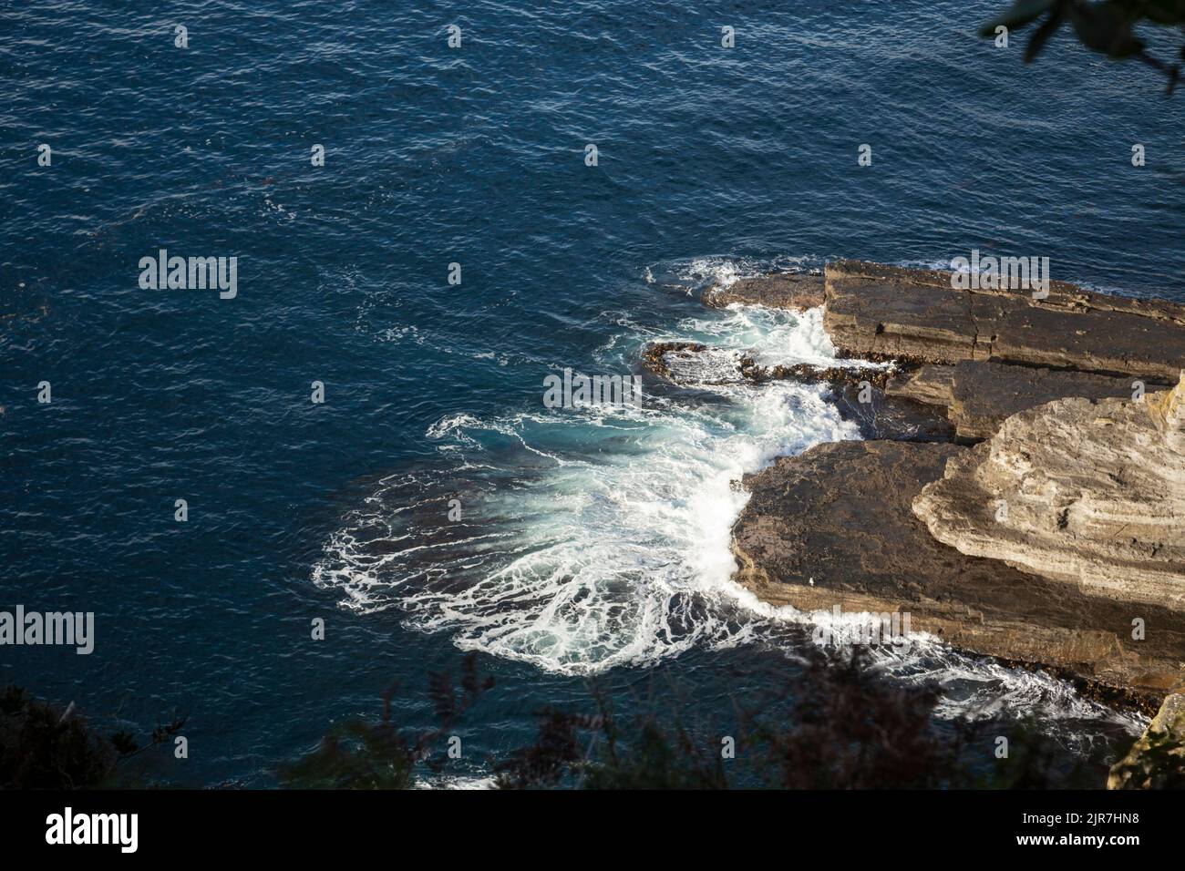 waves crashing on the Tasmanian coast line. The beautiful blue pacific ...