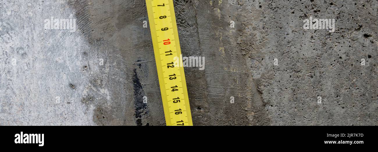 Measuring ruler on a concrete wall texture. The concept of renovation ...