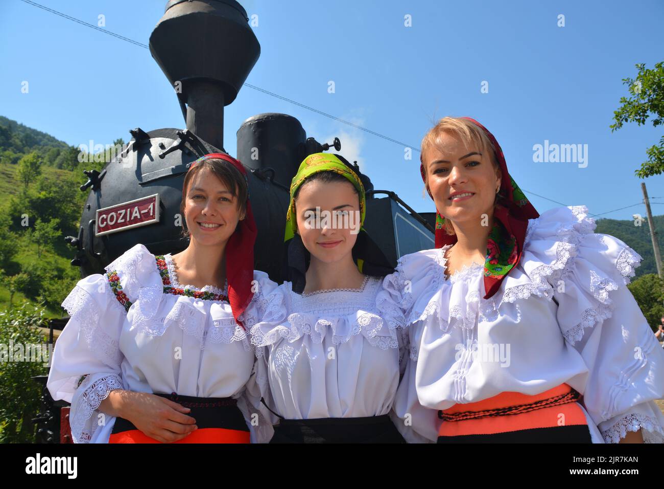 Three Romanian girls from Maramures County, Viseu de Sus, against the ...