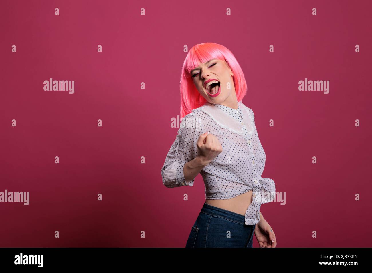 Happy female model celebrating successful triumph and victory, enjoying ...