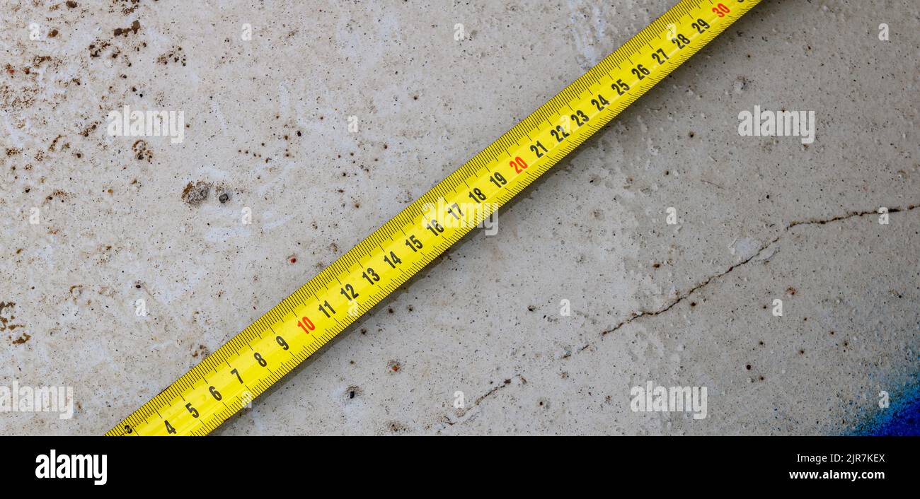 Measuring ruler on a concrete wall texture. The concept of renovation ...