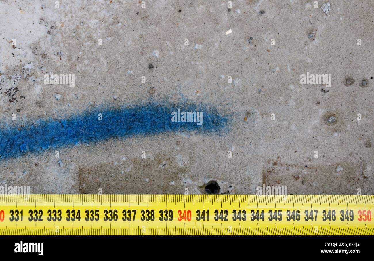 Measuring ruler on a concrete wall texture. The concept of renovation ...