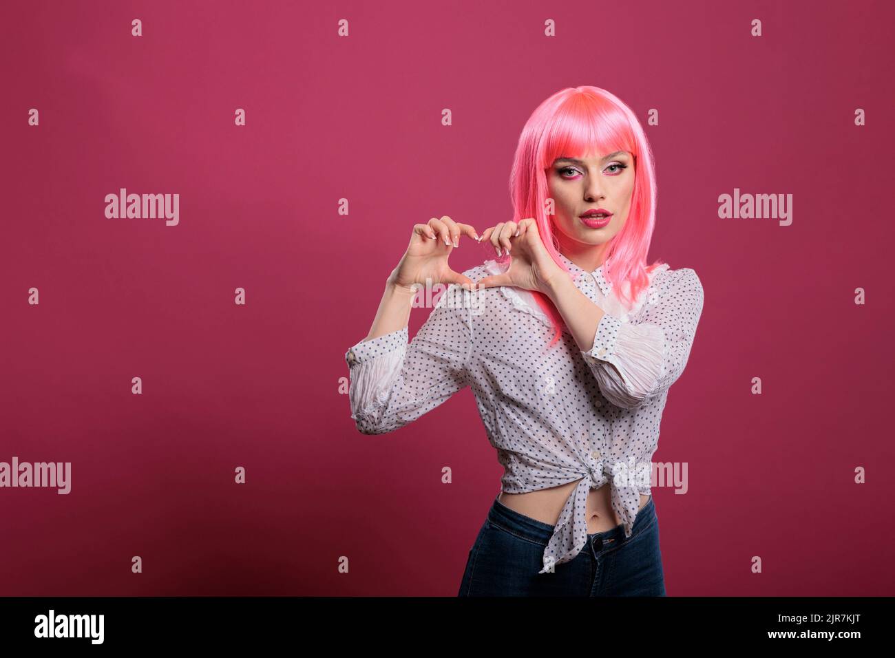 Positive person showing romantic heart shaped sign on camera, doing ...