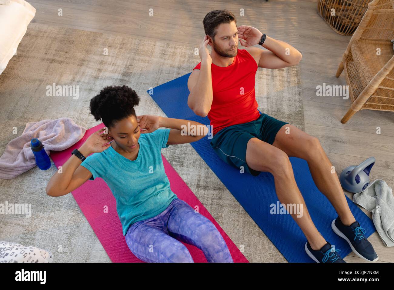Image of diverse couple exercising at home Stock Photo - Alamy