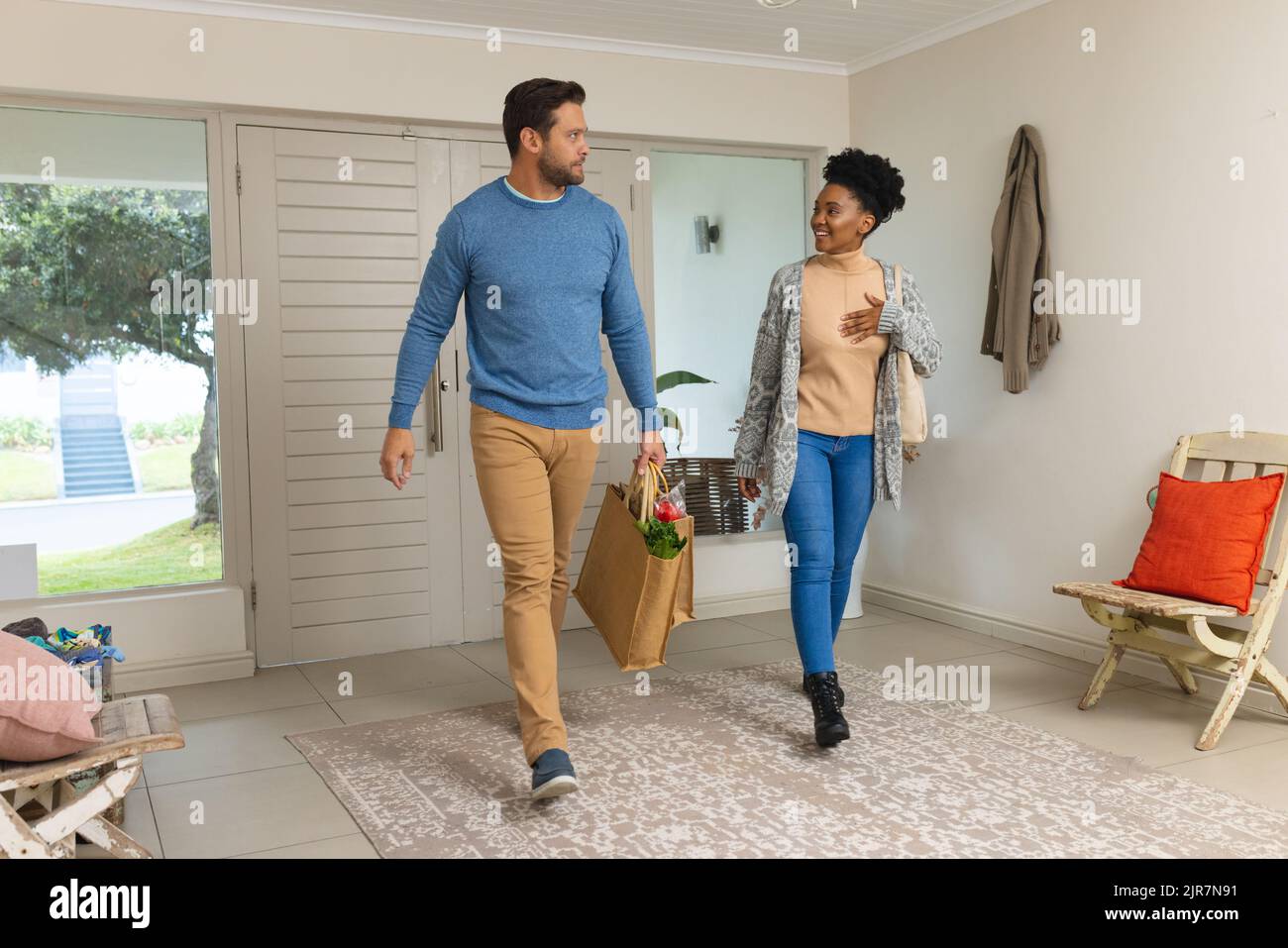 Image of happy diverse couple returning home with shopping Stock Photo ...