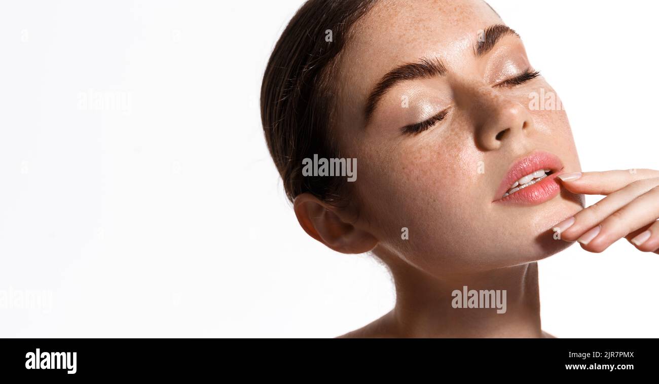 Happy Beautiful Girl Holding Her Cheeks With A Laugh Looking To The
