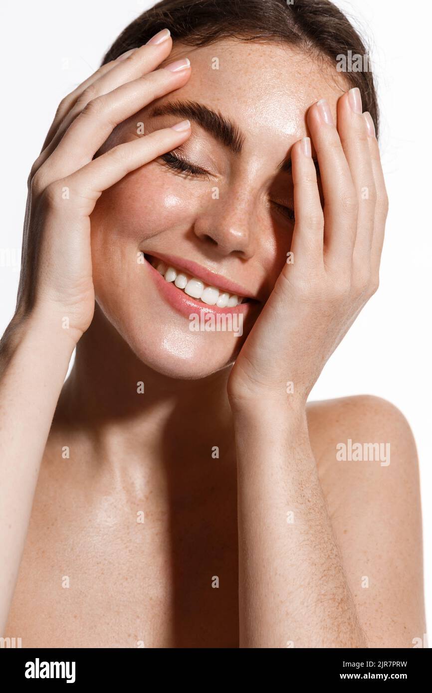 Vertical portrait of beautiful girl smiling, touching natural face ...