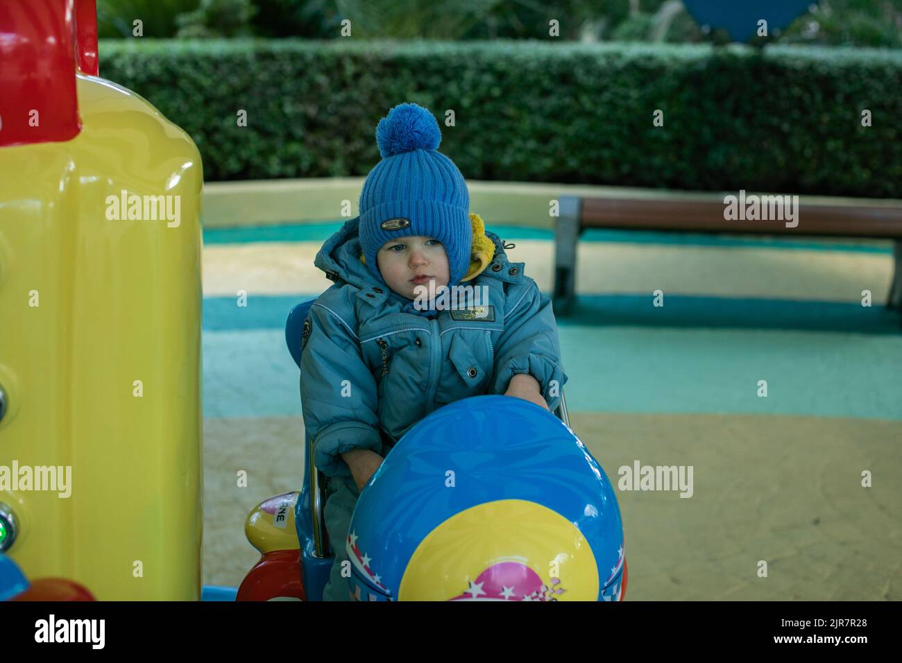 happy little boy driving a car on merry-go-round Stock Photo - Alamy