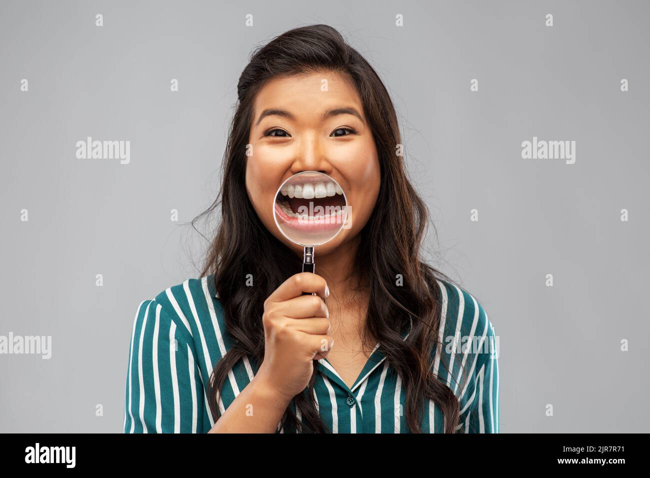 asian woman shows teeth through magnifying glass Stock Photo - Alamy