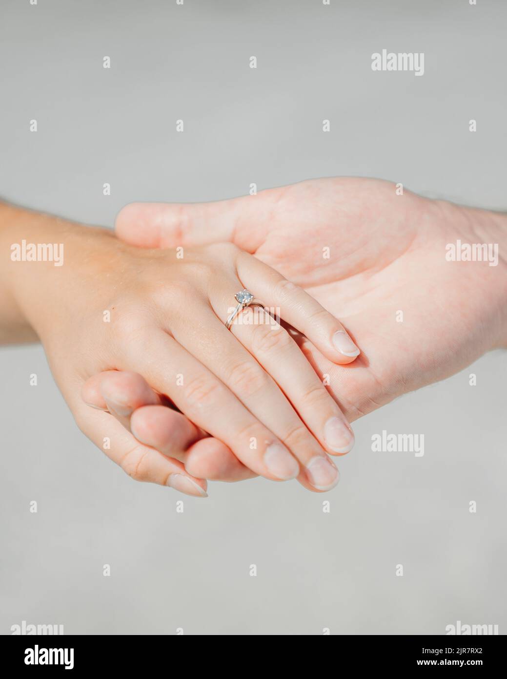 Couple hands wedding band hi-res stock photography and images - Alamy