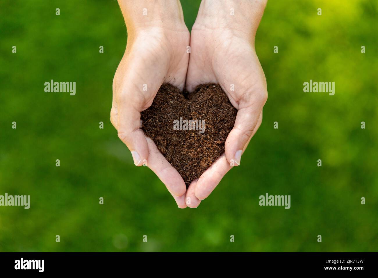 cupped hands holding soil in shape of heart Stock Photo - Alamy