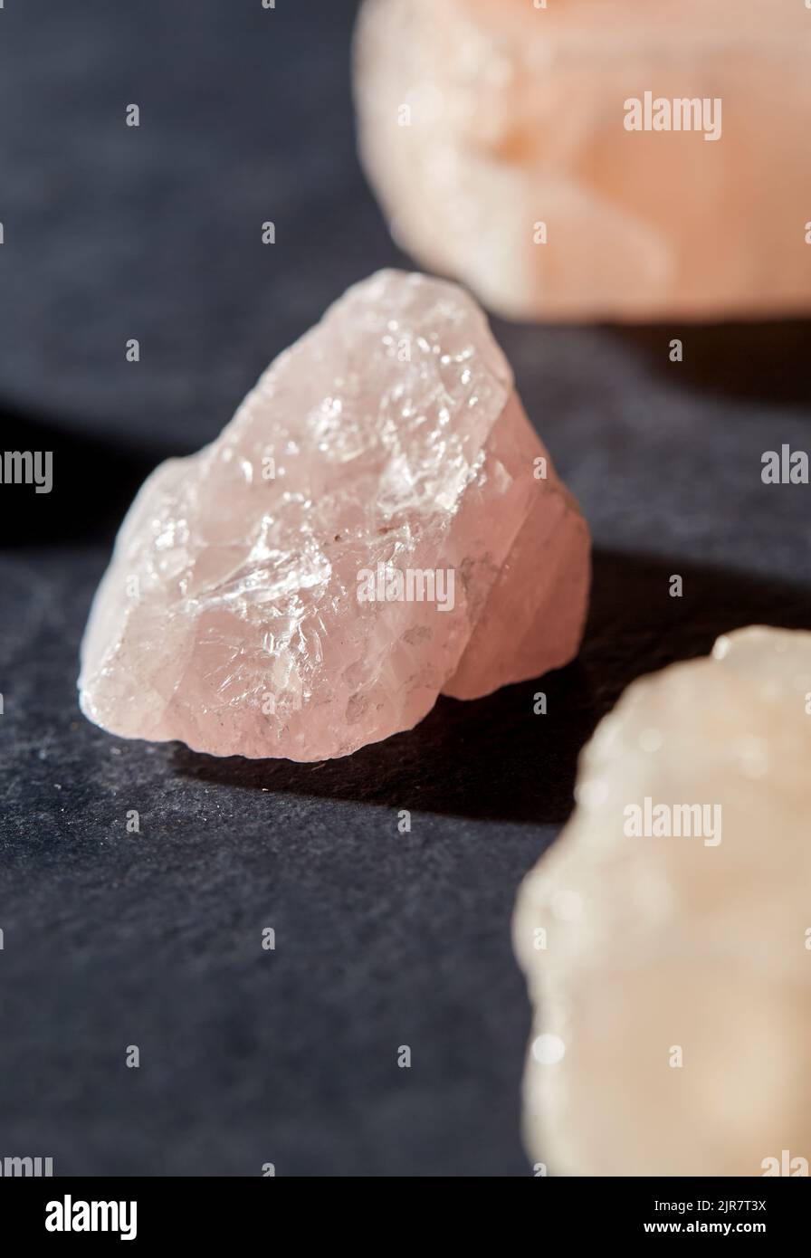 raw rose quartz crystals on black slate background Stock Photo - Alamy