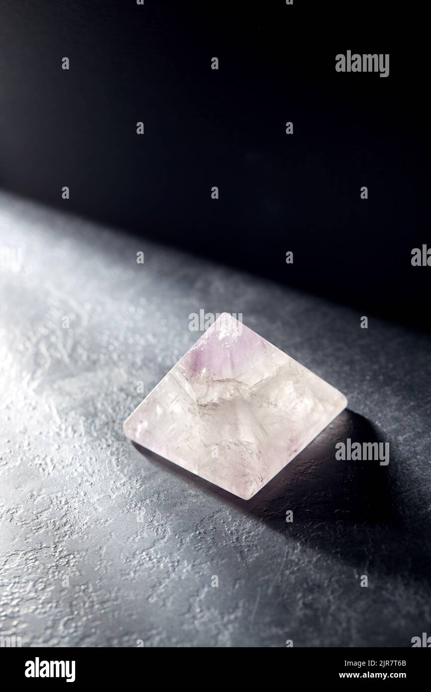 quartz crystal pyramid on slate stone in darkness Stock Photo - Alamy