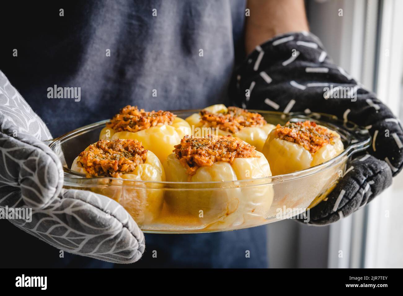 Unknown man hands hold Traditional food classic stuffed bell peepers ...