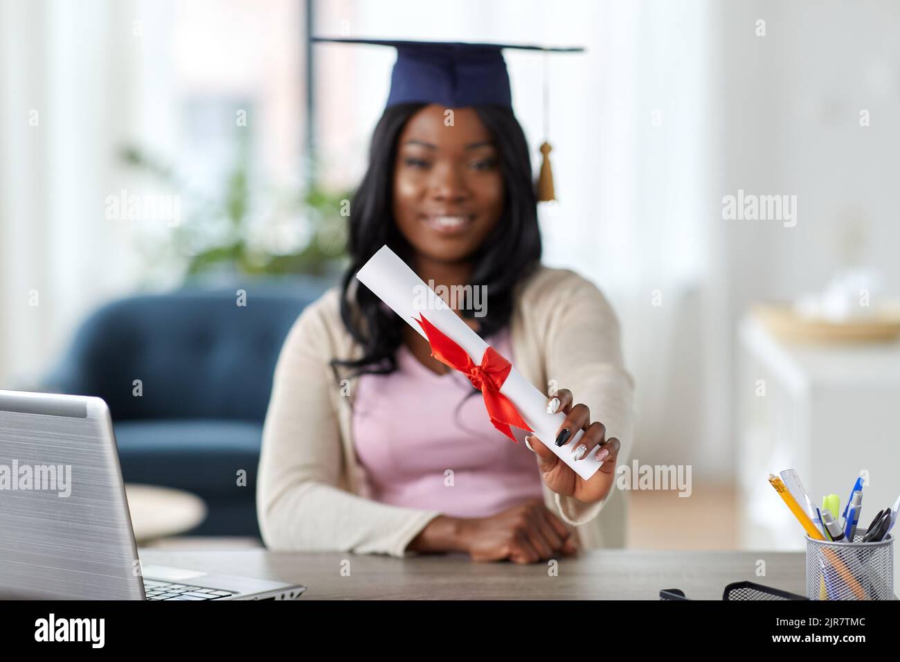graduate student with laptop and diploma at home Stock Photo - Alamy